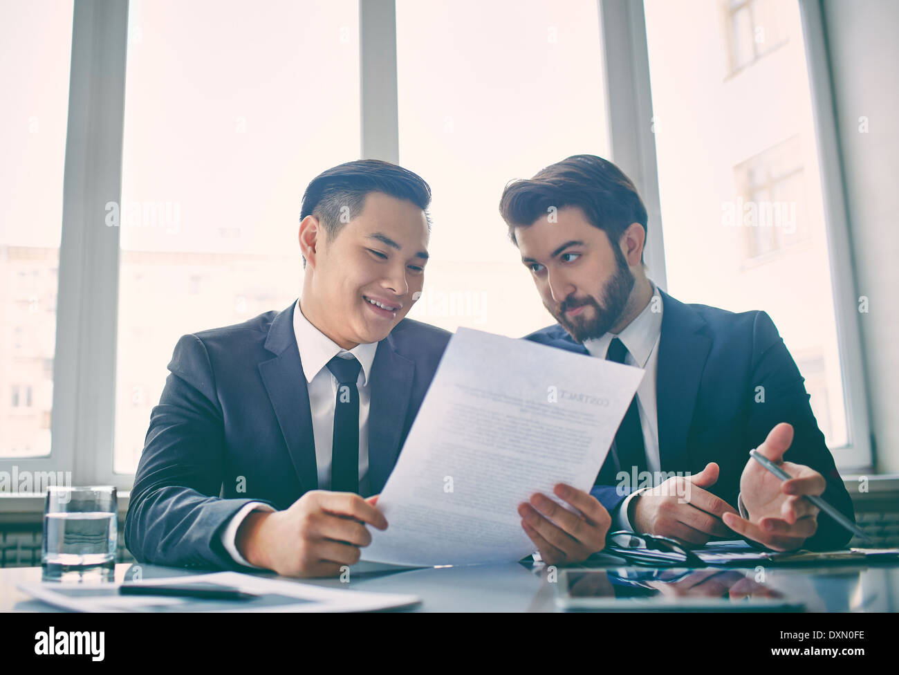 Two managers discussing contract in meeting room Stock Photo - Alamy