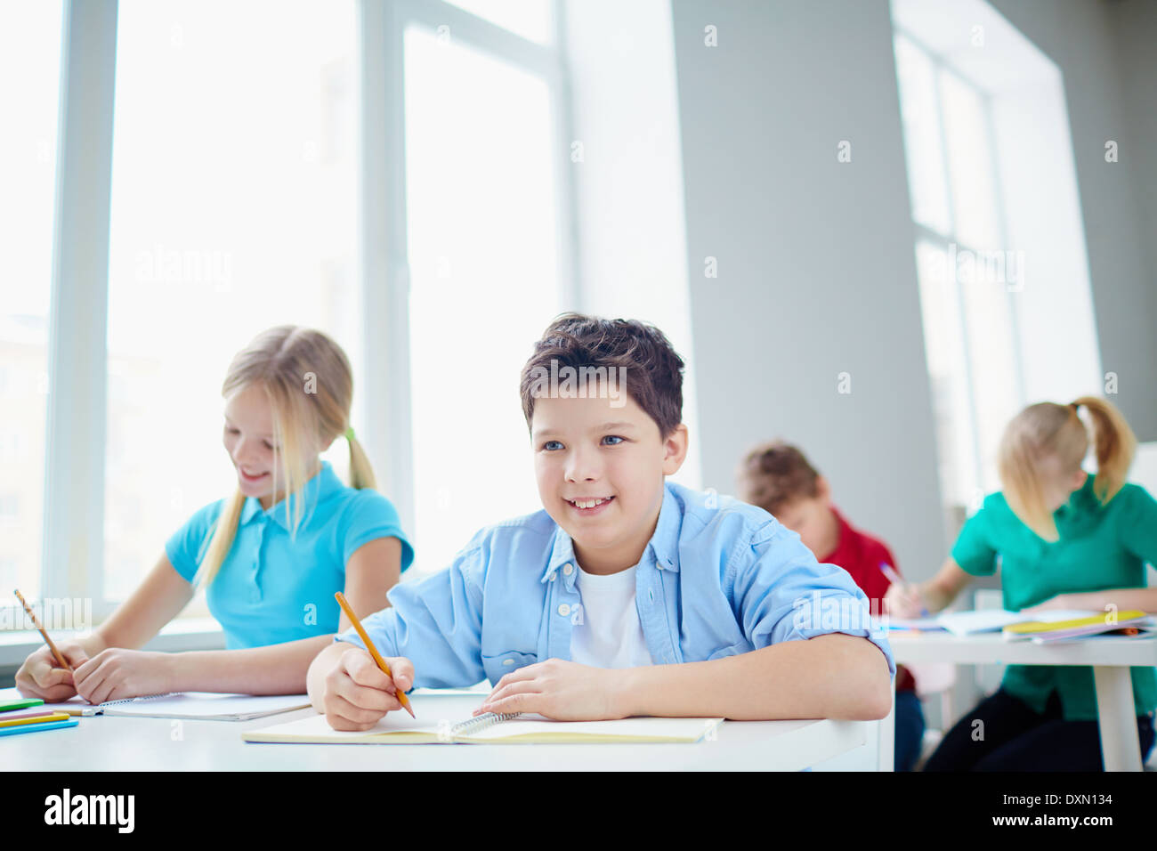Portrait of diligent pupils drawing at lesson in classroom Stock Photo ...