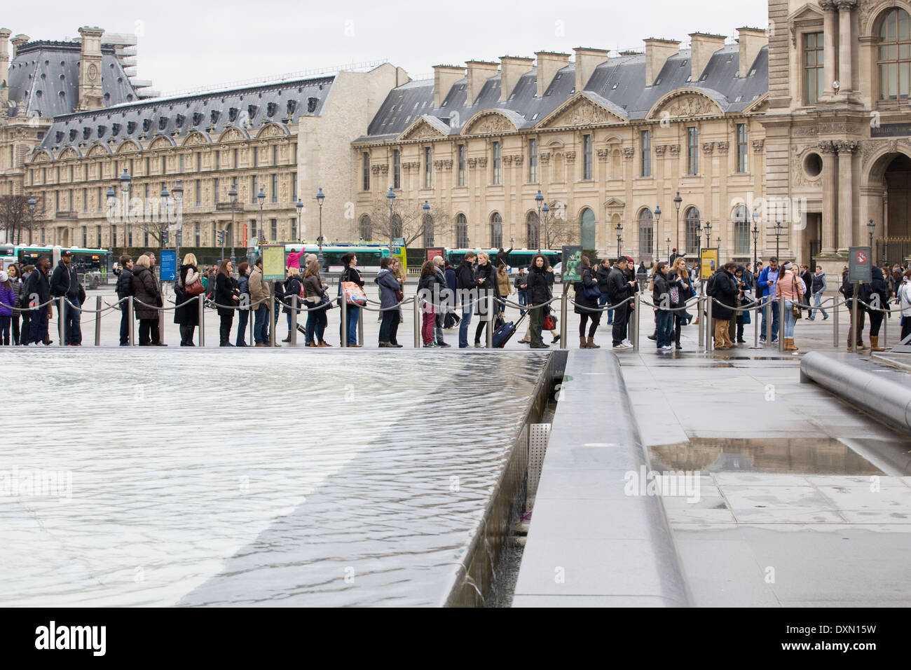 Crowds queuing to get in to The Louvre Pyramid, part of the Louvre ...