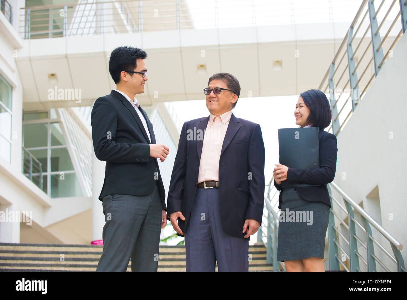 asian business team in conversation with office background Stock Photo ...