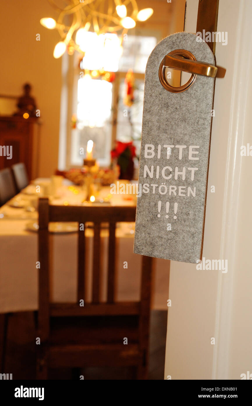 Sign 'do not disturb' at door of hotel room in front of laid table ...