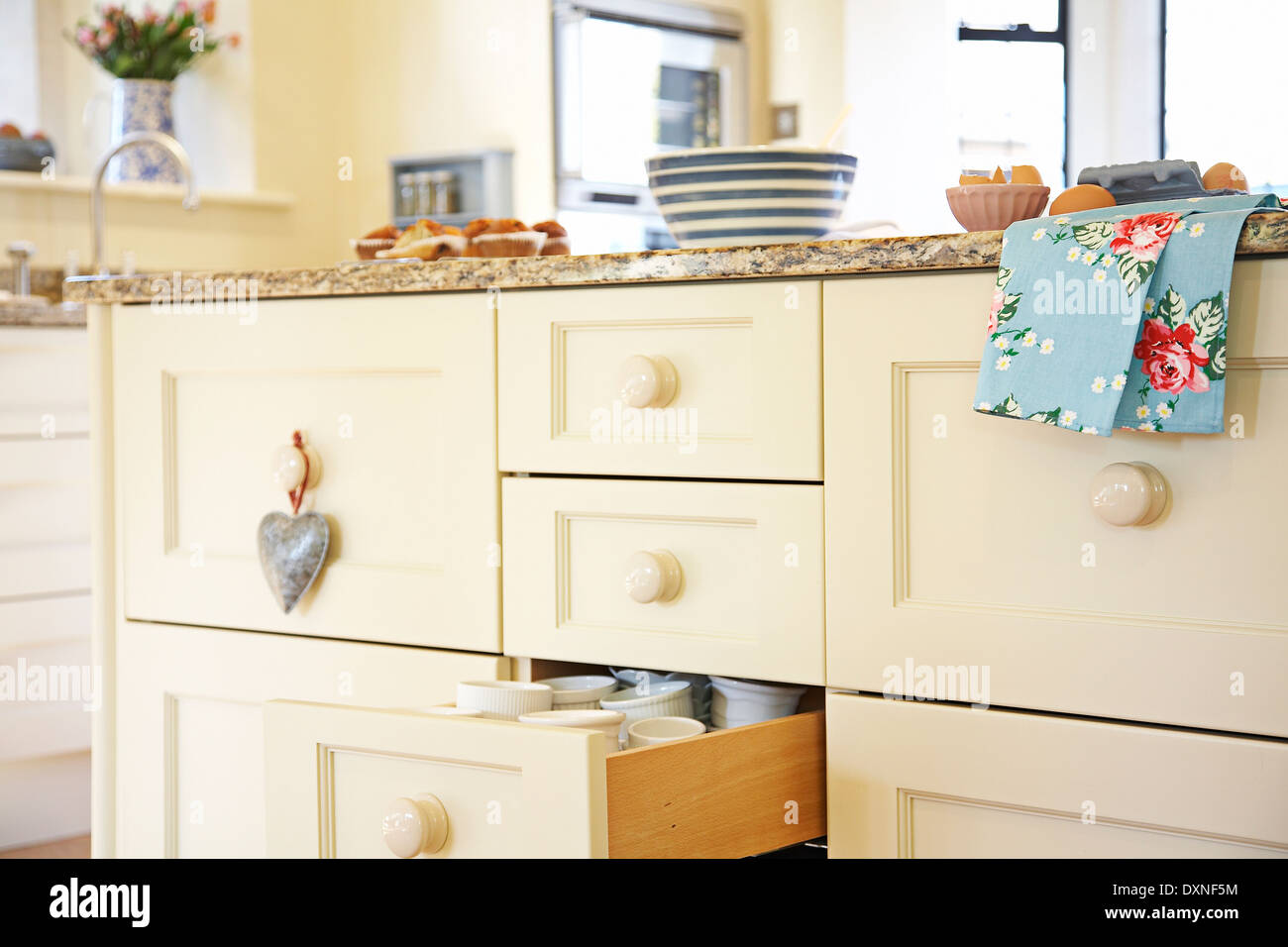 Detail of a large modern cream country kitchen with open drawer in a ...