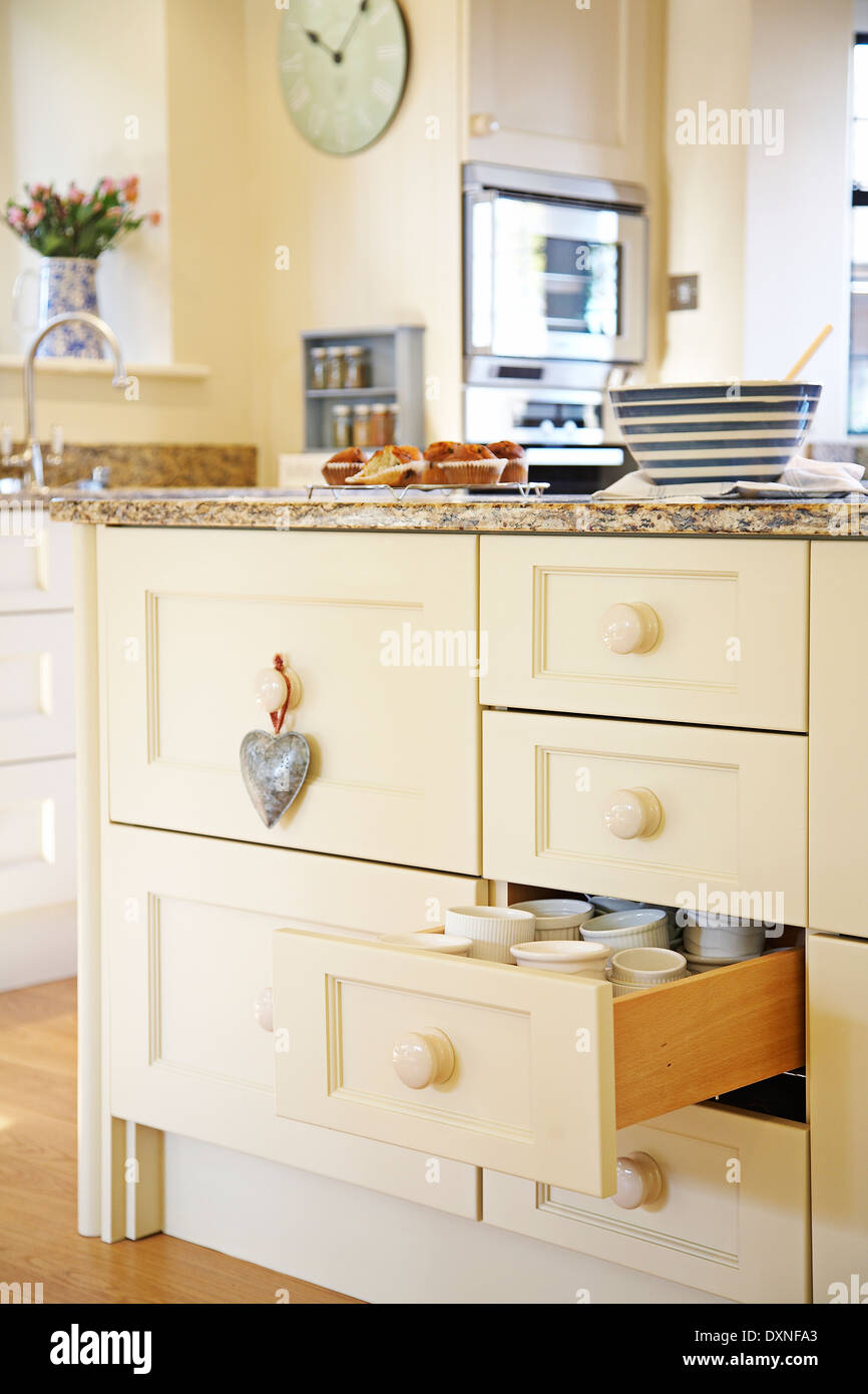 Detail of a large modern cream country kitchen with open drawer in a ...