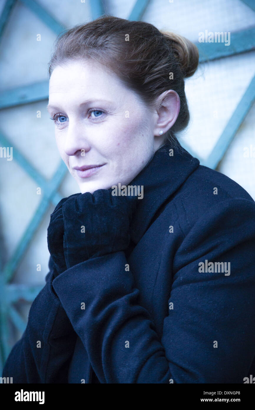 Portrait of woman keeping shut her collar Stock Photo - Alamy