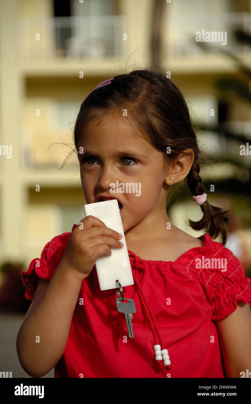 Young child is holding a hotel key Stock Photo - Alamy