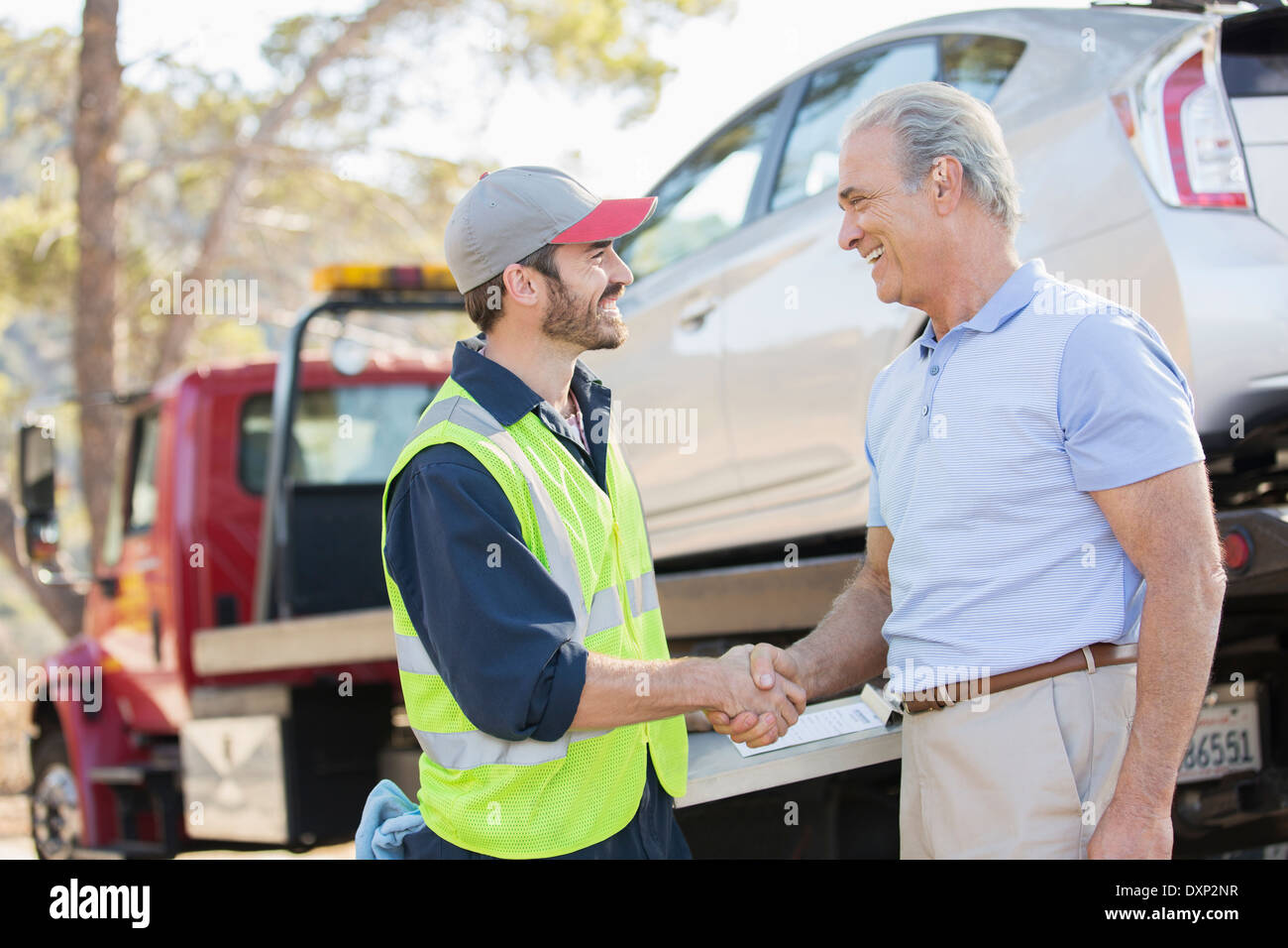 Roadside mechanic and man shaking hands Stock Photo - Alamy