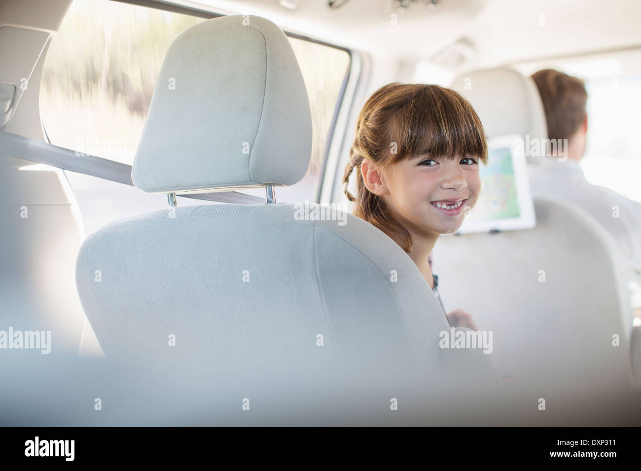 Portrait of smiling girl in back seat of car Stock Photo - Alamy