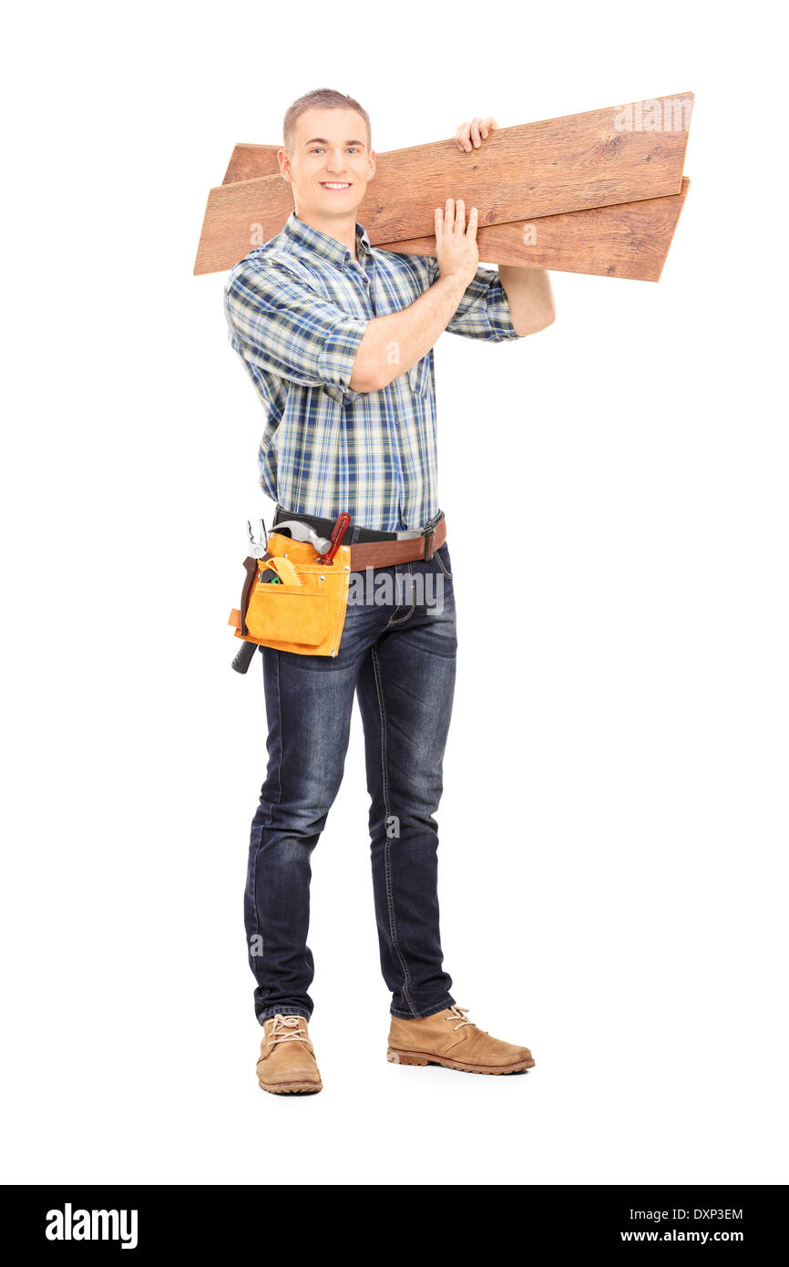 Full length portrait of a male carpenter carrying planks over his ...