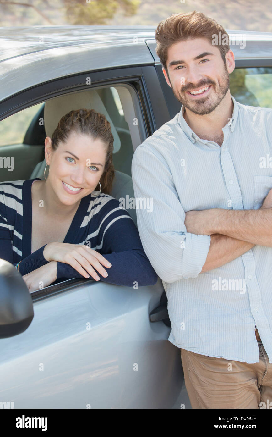 Portrait of smiling couple inside and outside car Stock Photo - Alamy