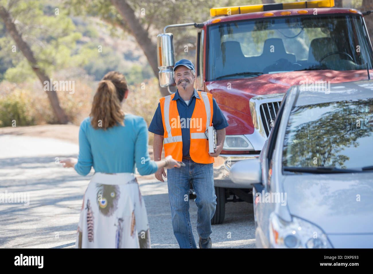 Woman greeting roadside mechanic Stock Photo - Alamy