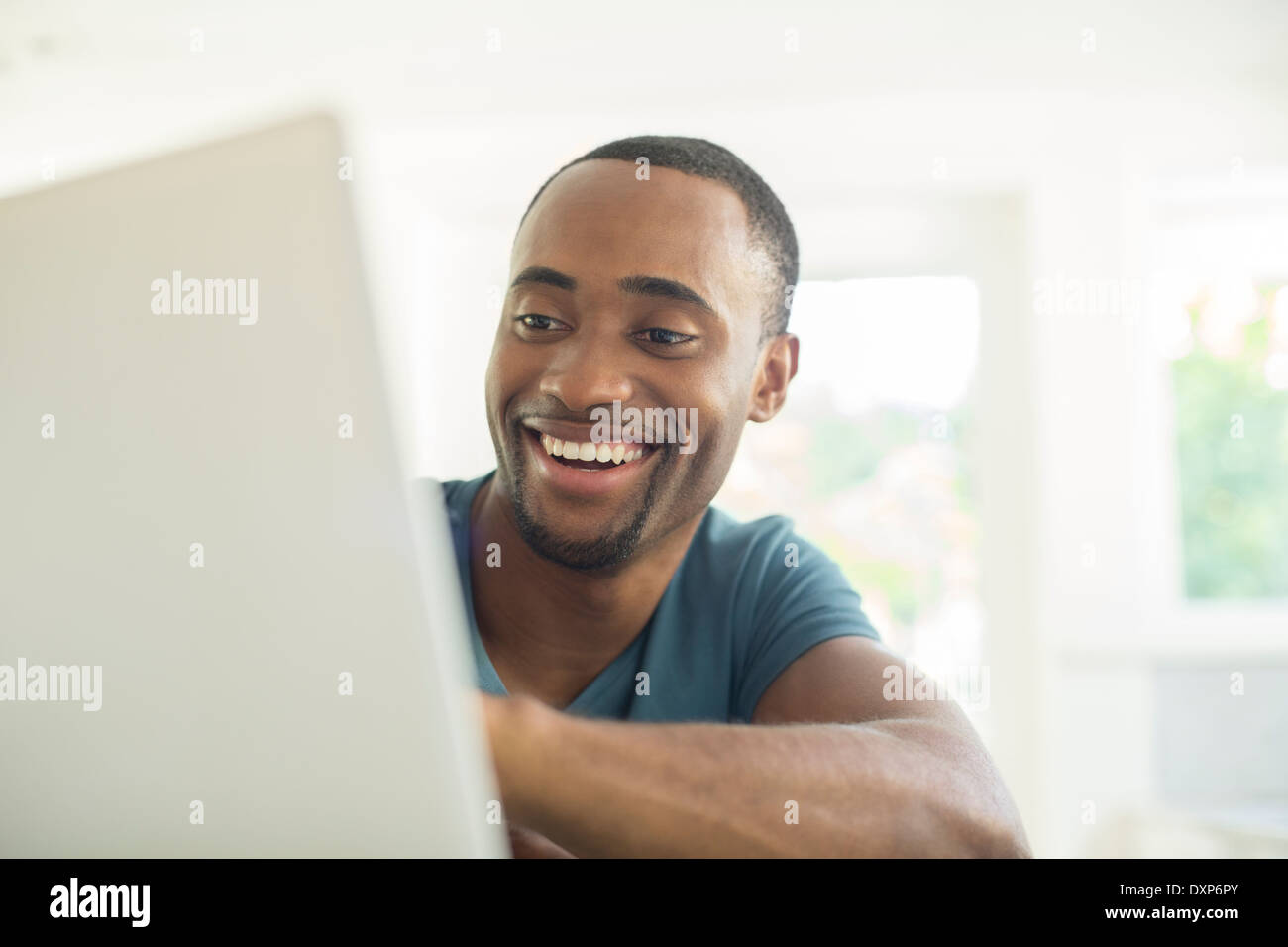 Happy man using laptop Stock Photo - Alamy
