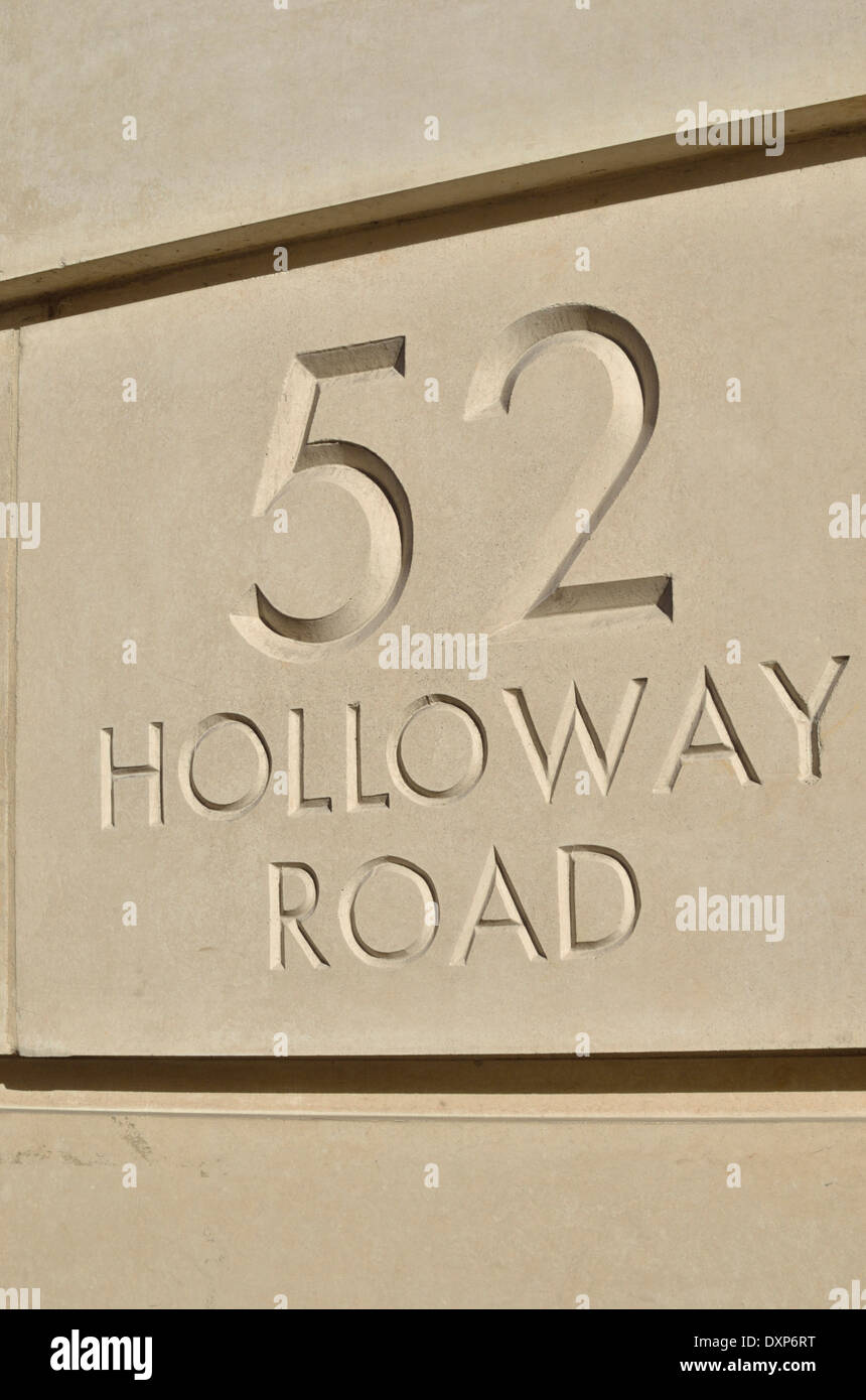 Number 52 Holloway Road sign carved into a stone wall, London, UK Stock ...