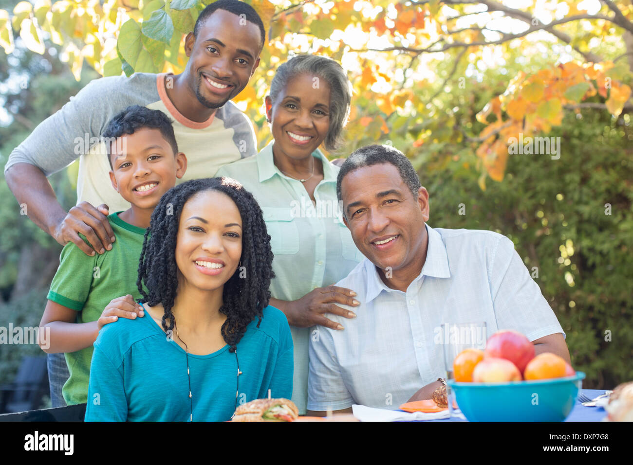 Portrait of smiling multi-generation family at patio table Stock Photo ...