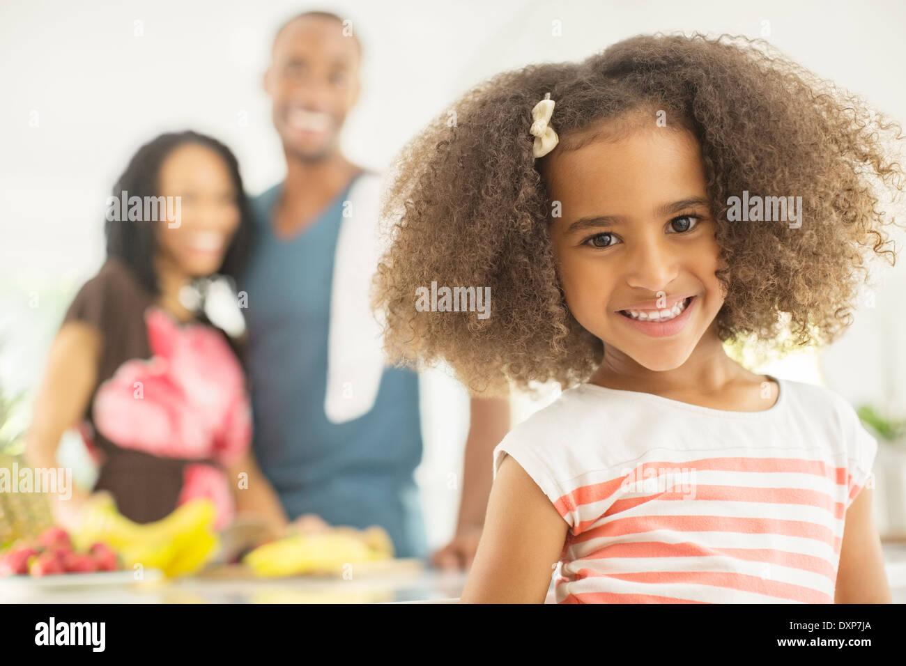 Portrait of smiling girl with parents in background Stock Photo - Alamy