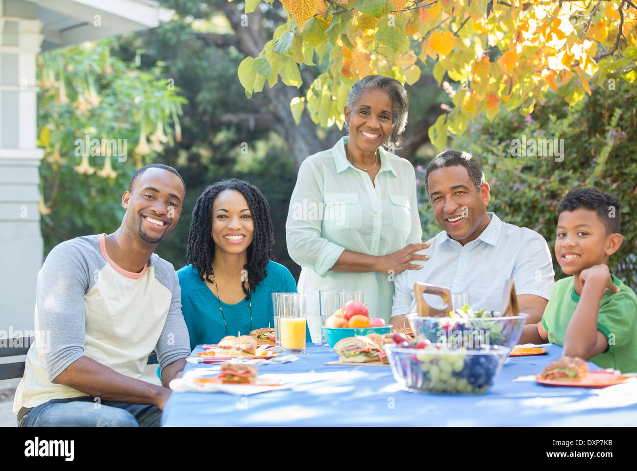 Portrait of smiling multi-generation family eating lunch on patio Stock ...
