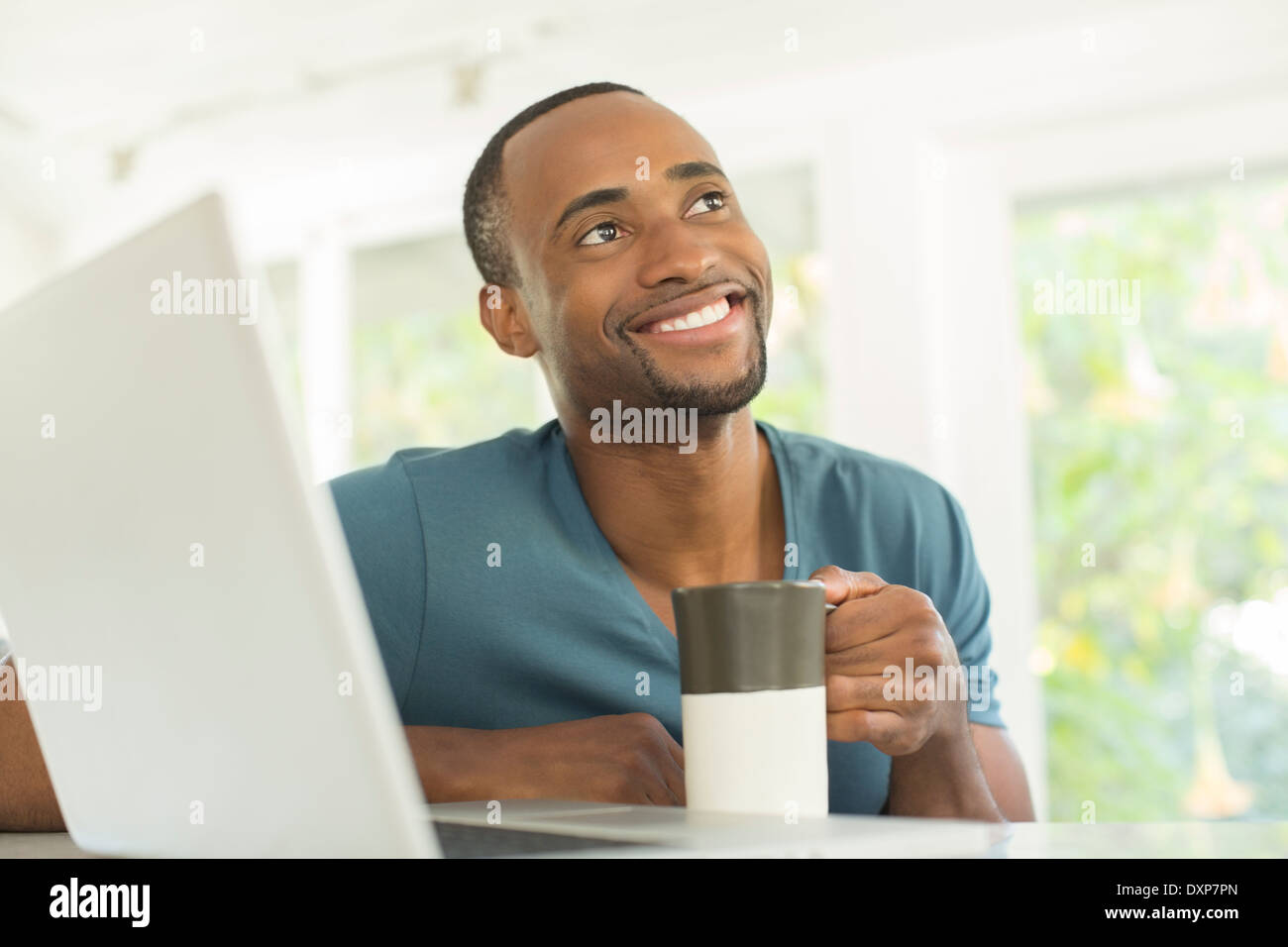 Young happy man drinking coffee hi-res stock photography and images - Alamy