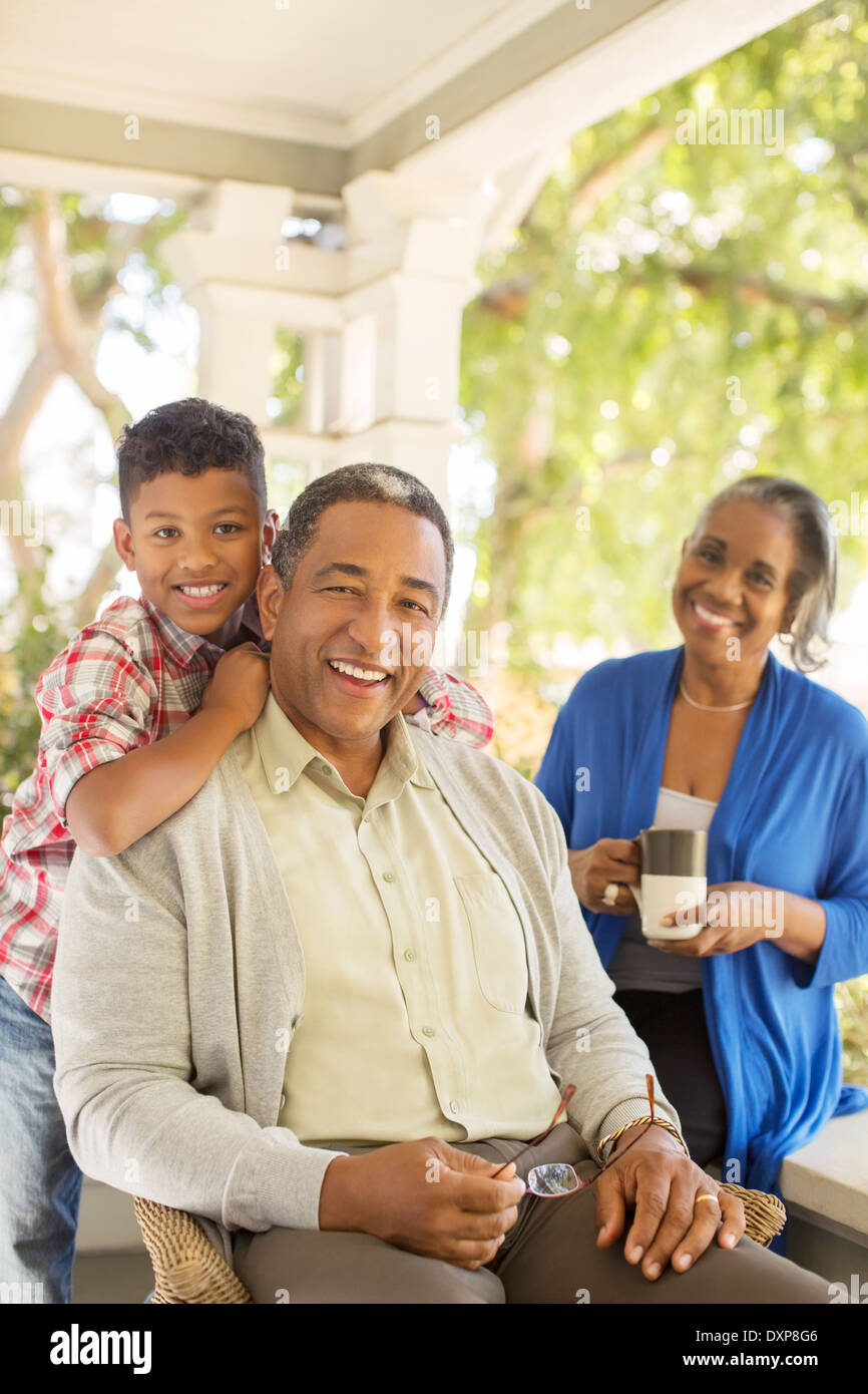 Portrait of smiling grandparents and grandson on porch Stock Photo - Alamy