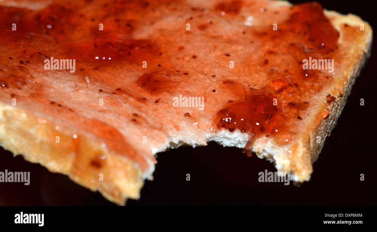 Strawberry Jam on Toast with bite mark Stock Photo - Alamy