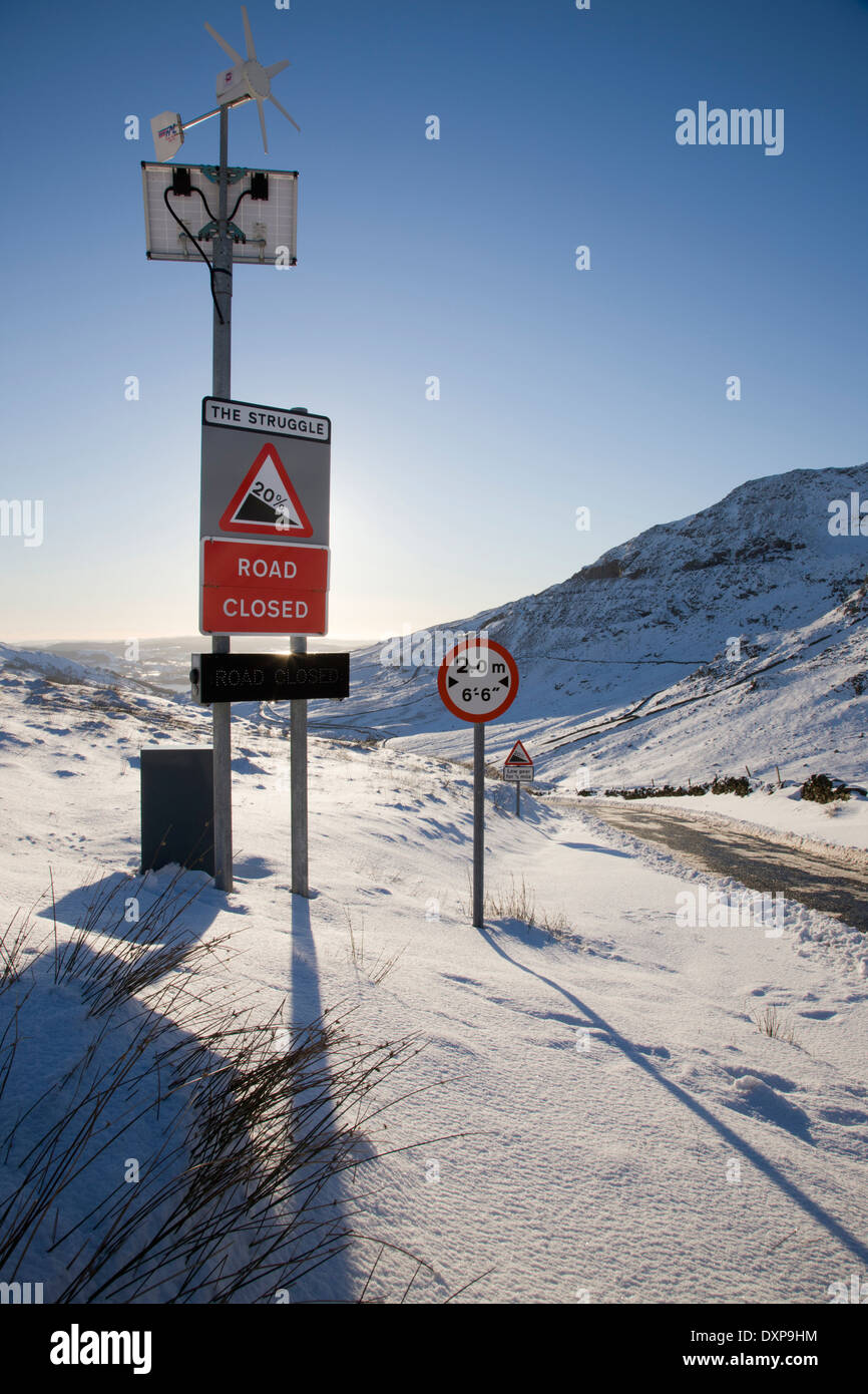 Wind and solar powered road sign showing closure of mountain highway ...