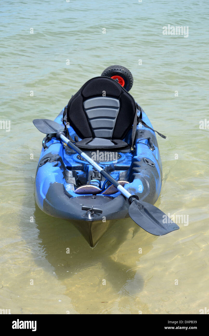 Blue / Black Camouflage Kayak with paddle and folded trolley in back ...