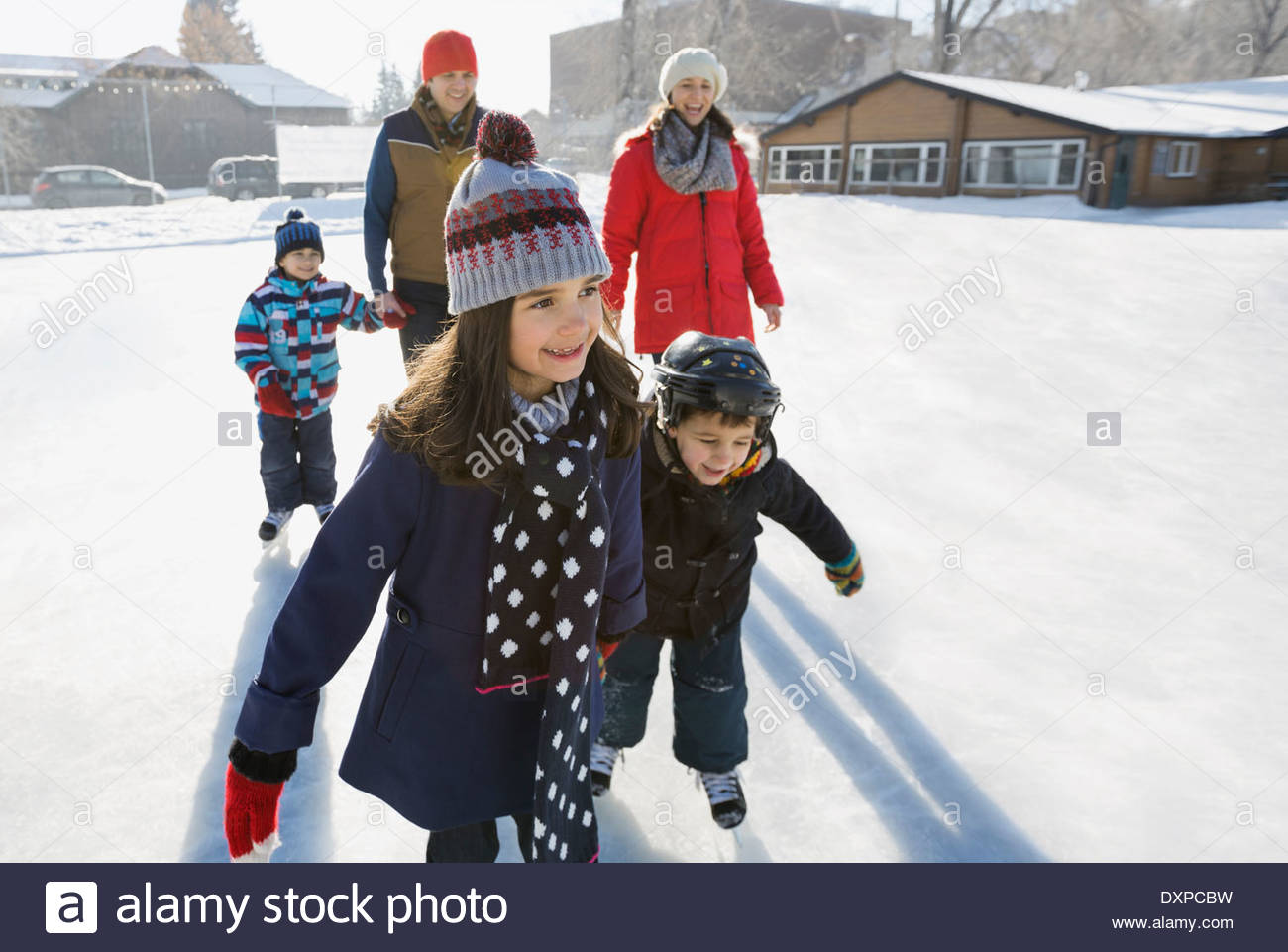 Family ice skating on outdoor rink hi-res stock photography and images ...