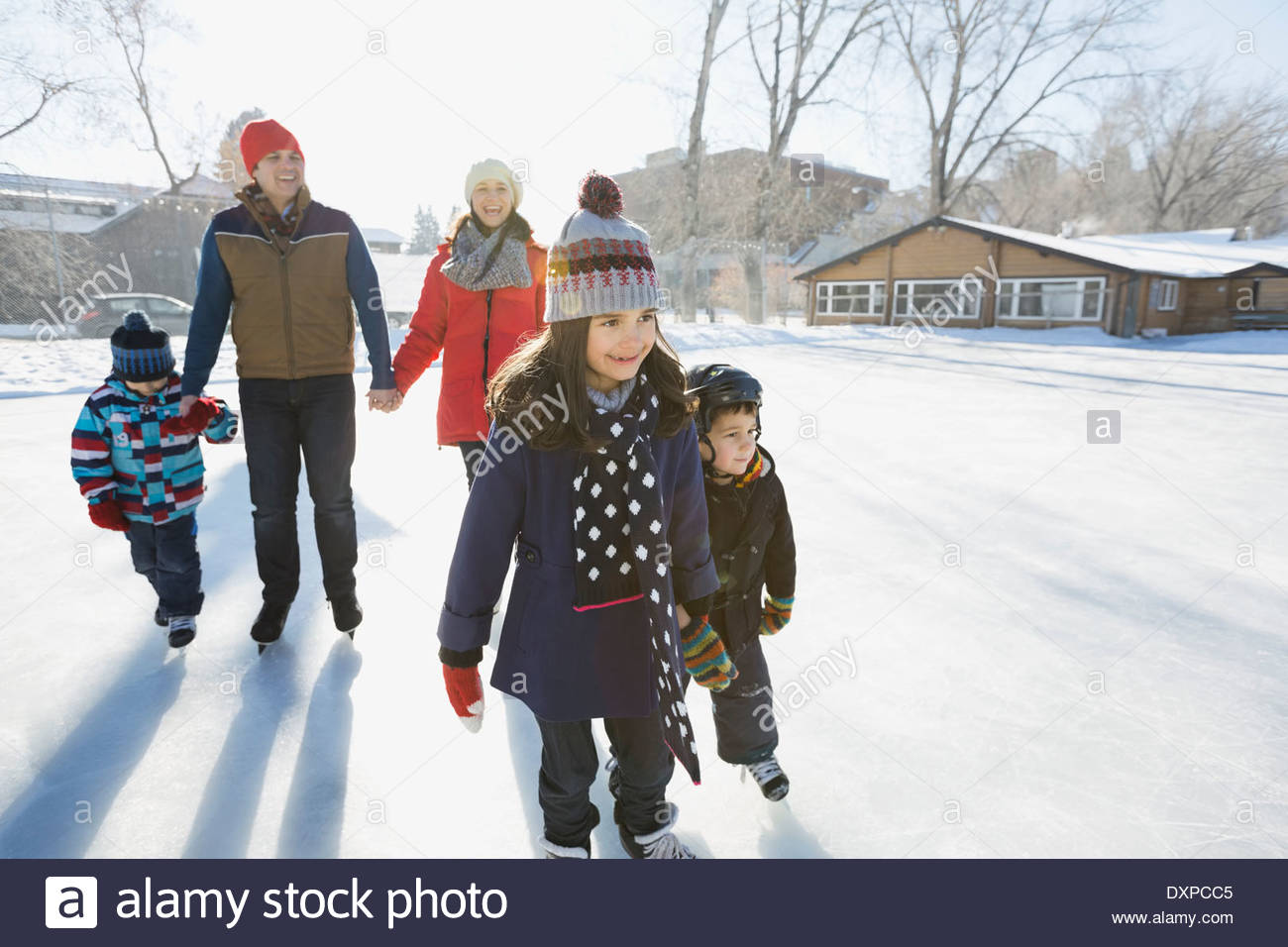 Family ice skating on outdoor rink hi-res stock photography and images ...