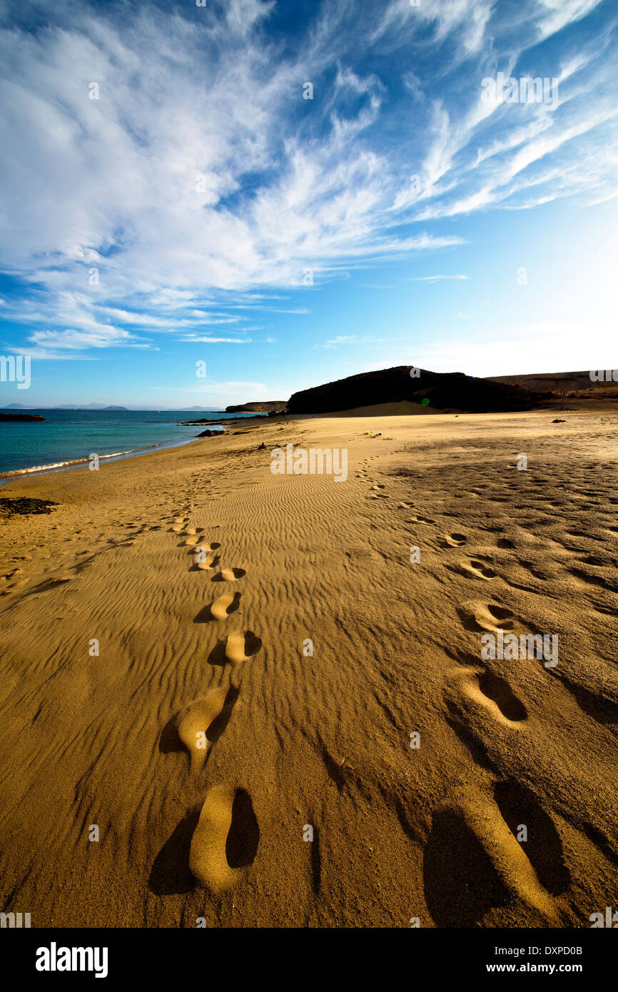 footstep in lanzarote spain rock stone sky cloud beach water musk pond ...