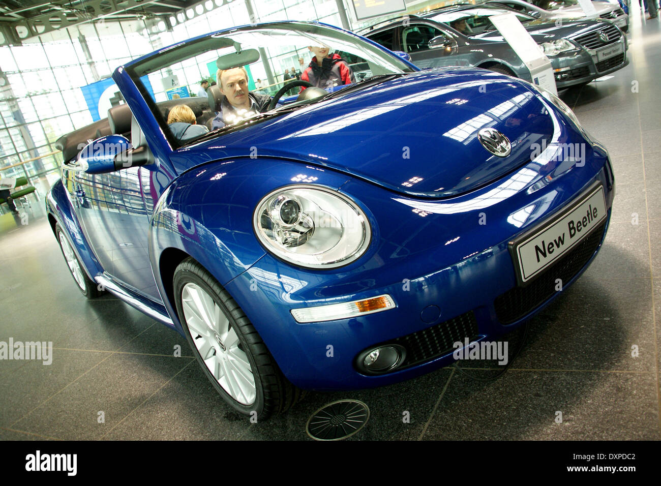 Wolfsburg, Germany, visitors look at a New Beetle at the Autostadt ...