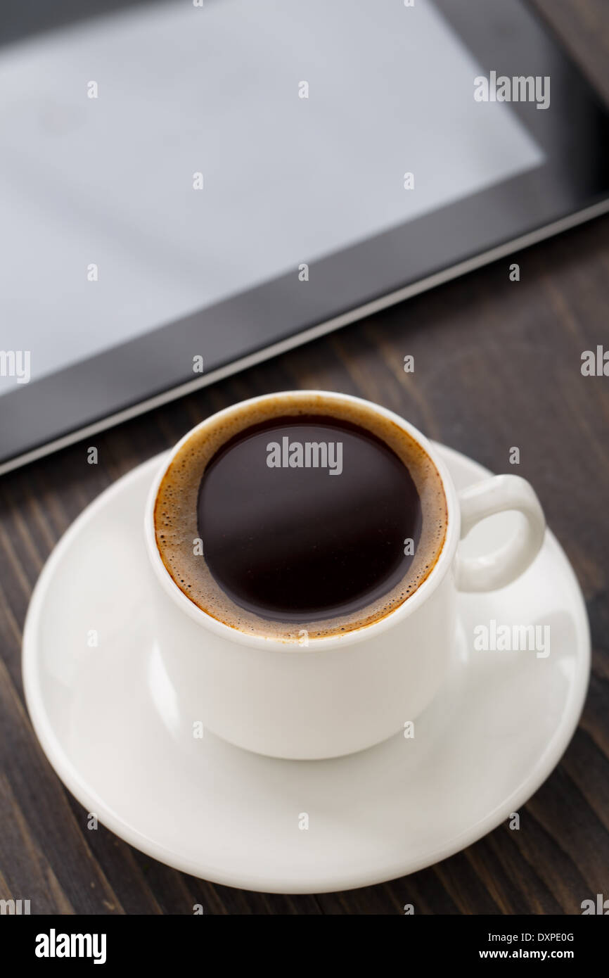 Cup of coffee and tablet Stock Photo - Alamy