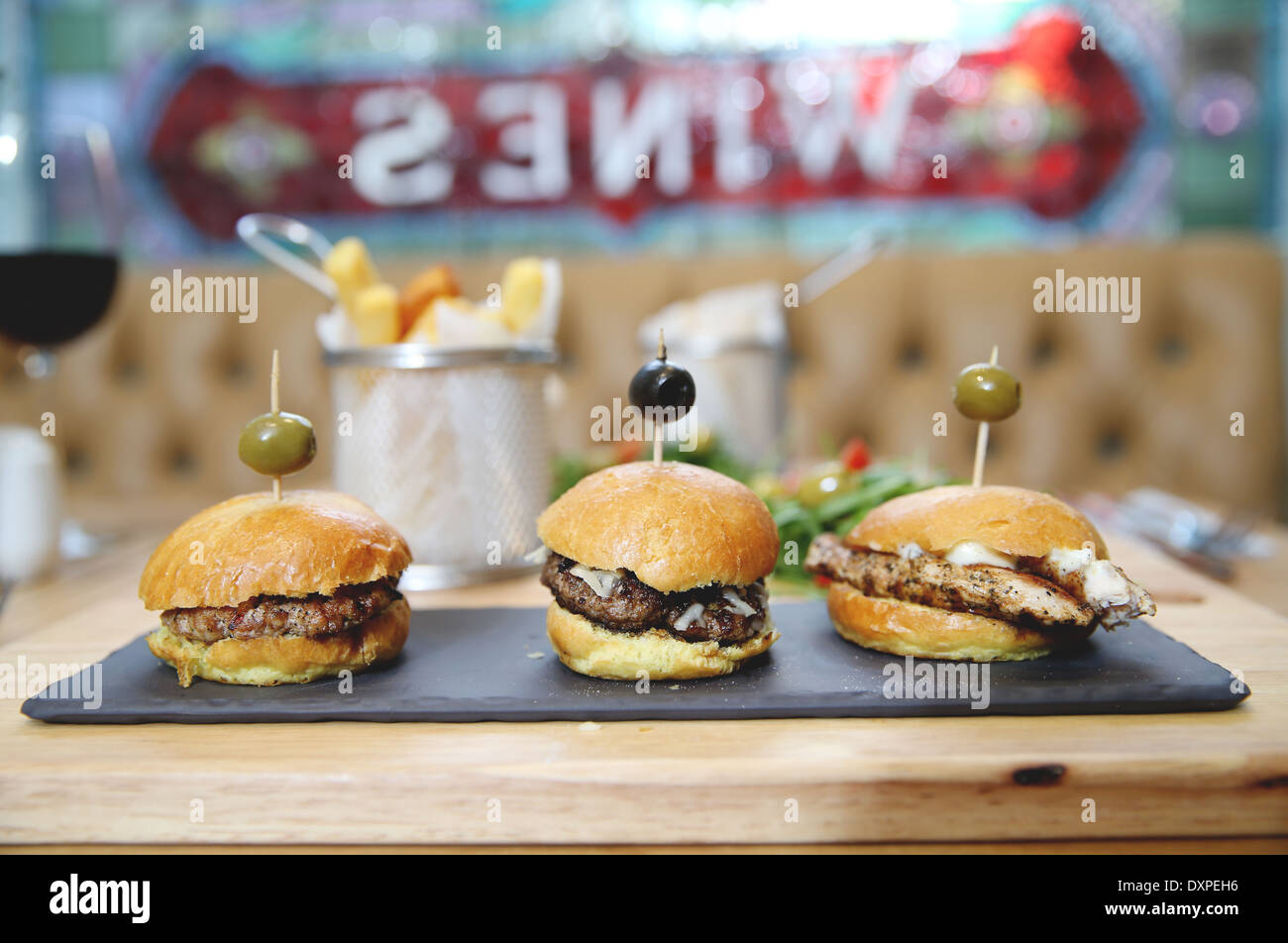 Great pub food consisting of Minni Burgers glass or red wine and chips ...