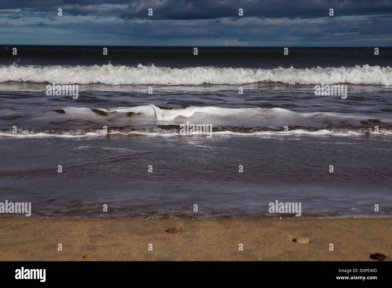 Waves rolling in on the beach near Craster, Northumberland Stock Photo ...