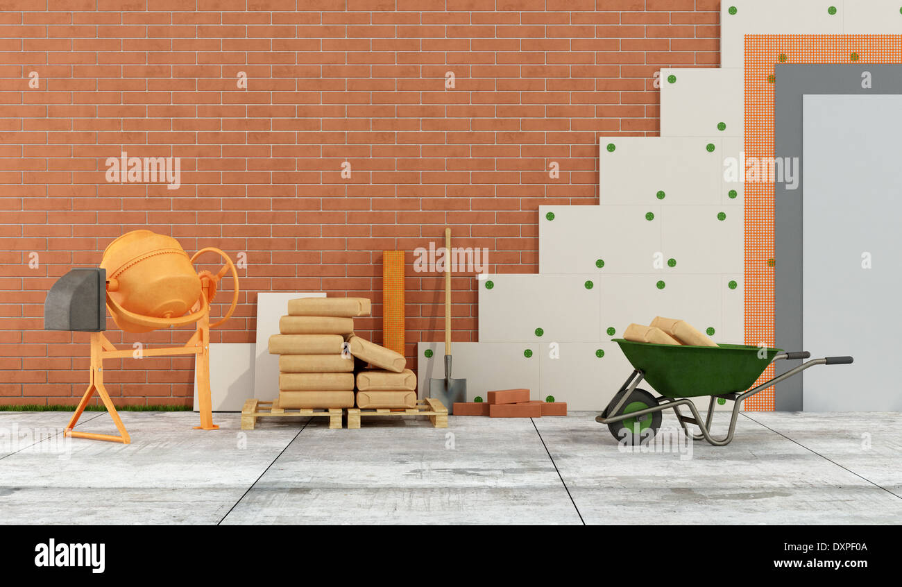 Construction site with concrete mixer, wheelbarrow, bags of cement and ...