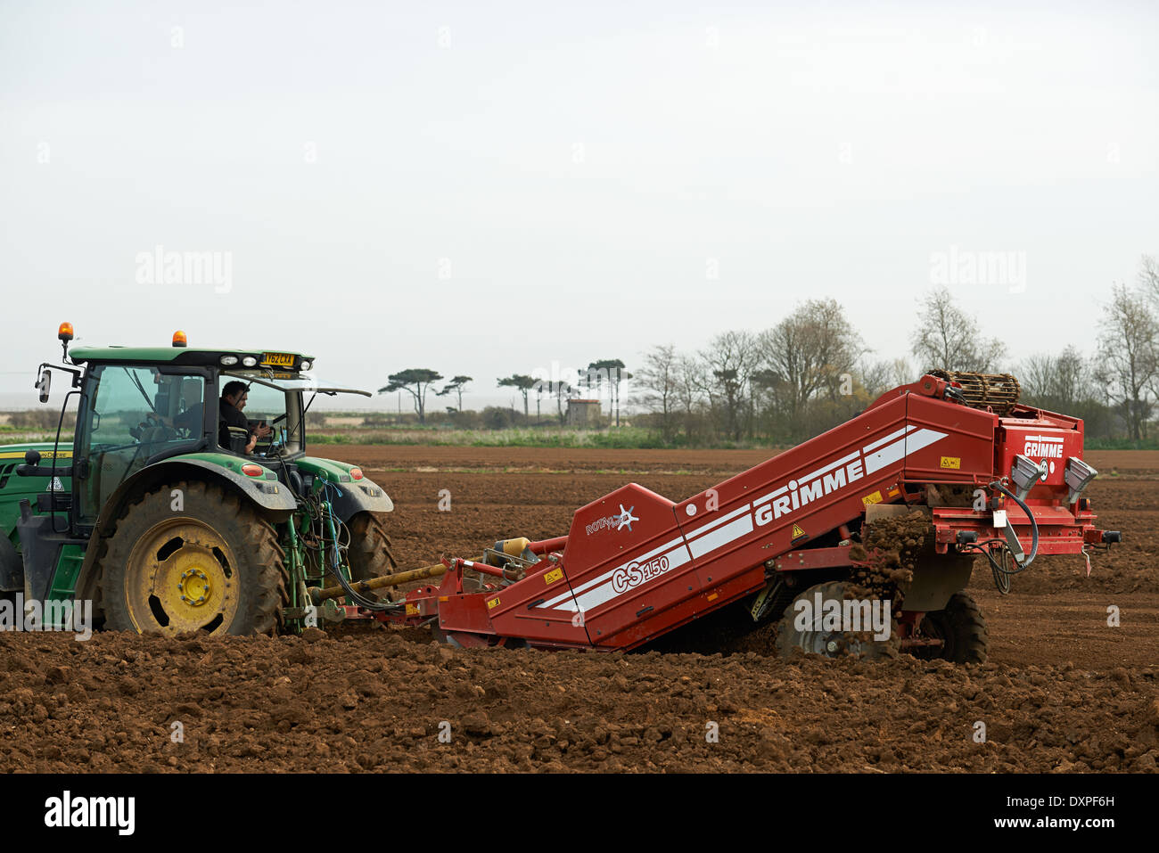 Arable farmland being de-stoned ready from the planting of potatoes ...