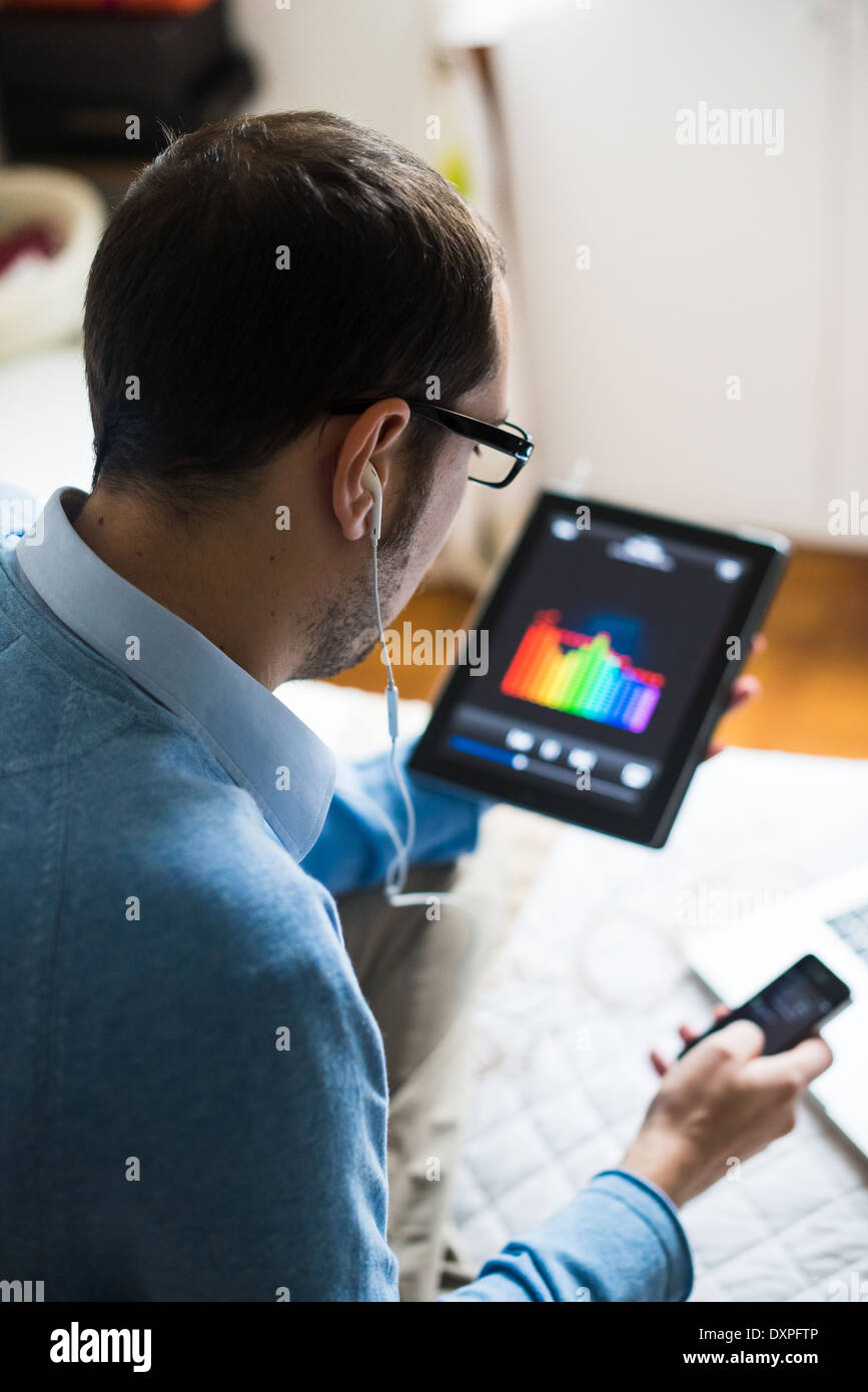 elegant business multitasking multimedia man using devices at home ...