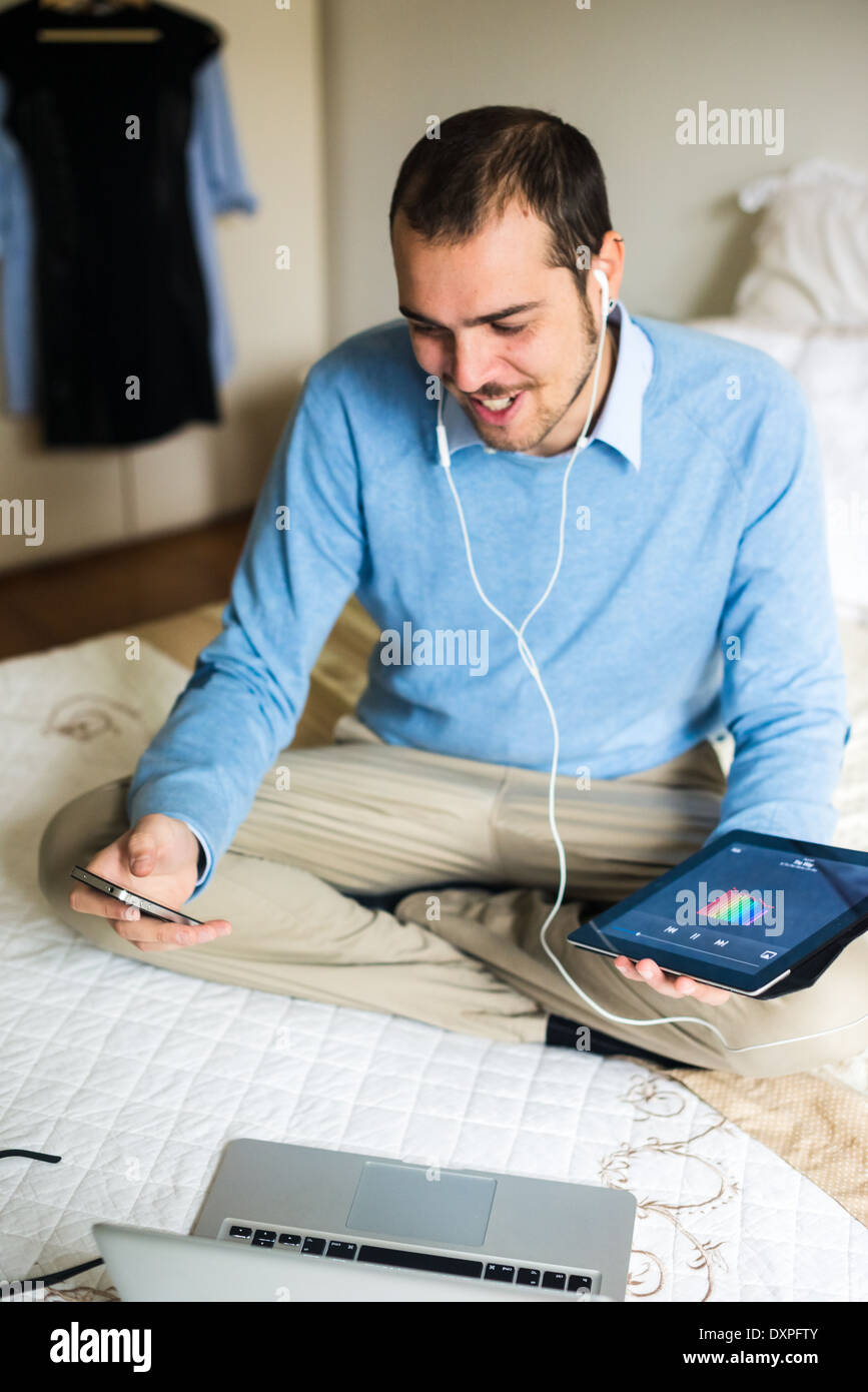 elegant business multitasking multimedia man using devices at home ...