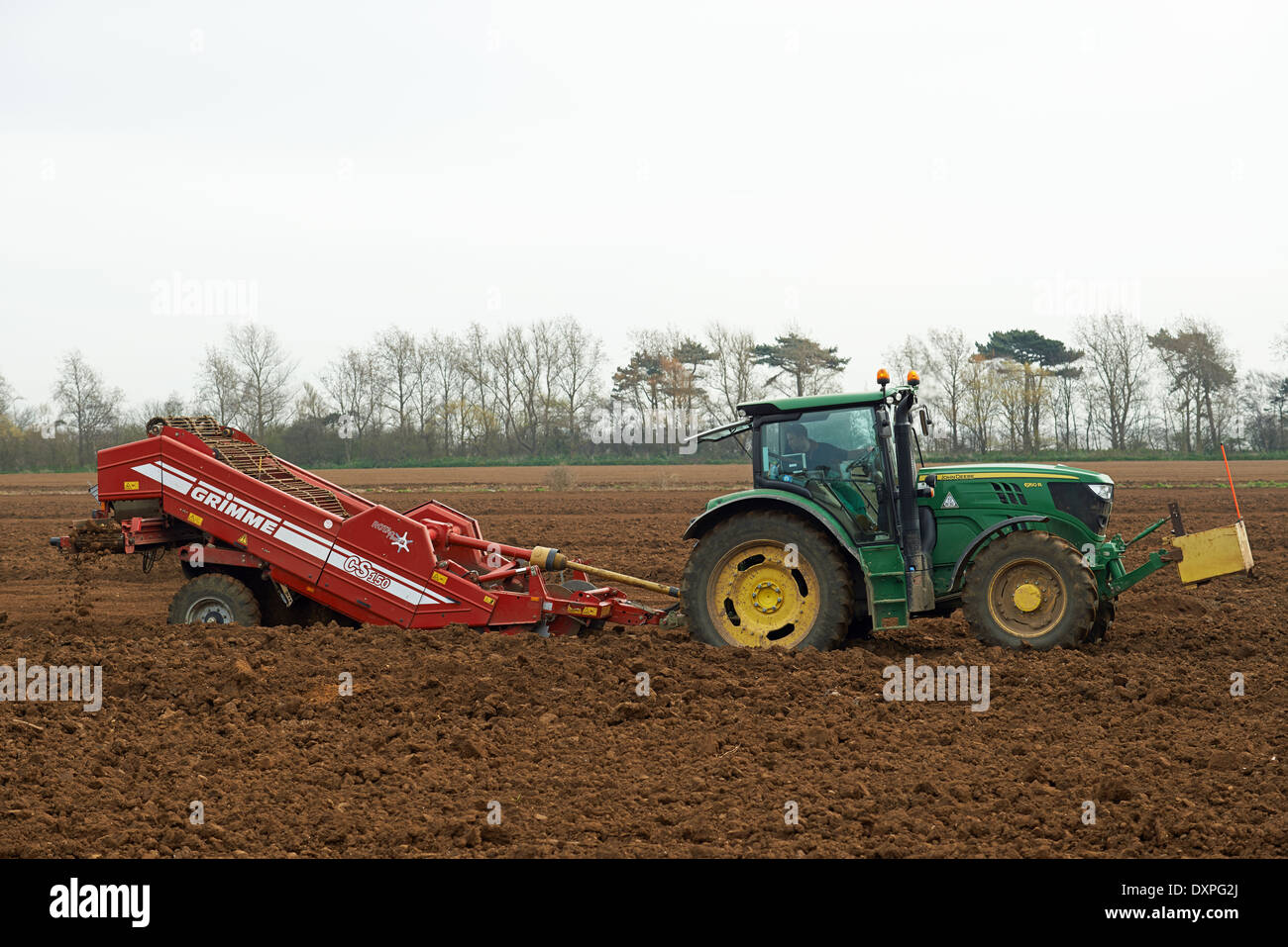 Arable farmland being de-stoned ready from the planting of potatoes ...