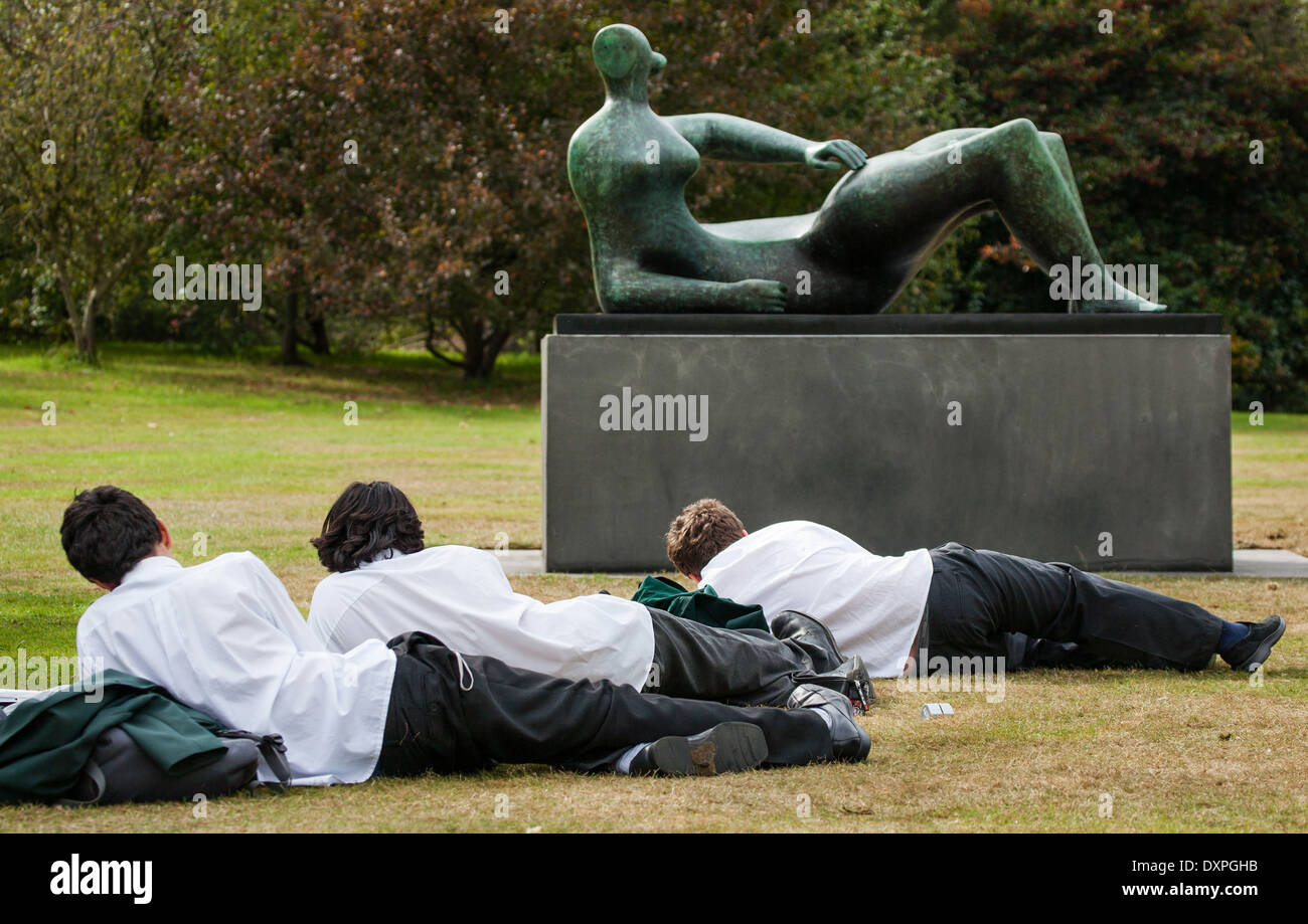 Reclining schoolboys drawing a bronze sculpture of a reclining female ...