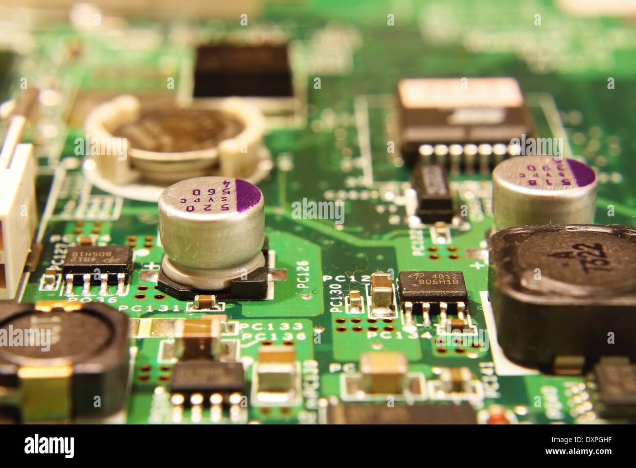 PCB with populated components on green layer Stock Photo - Alamy