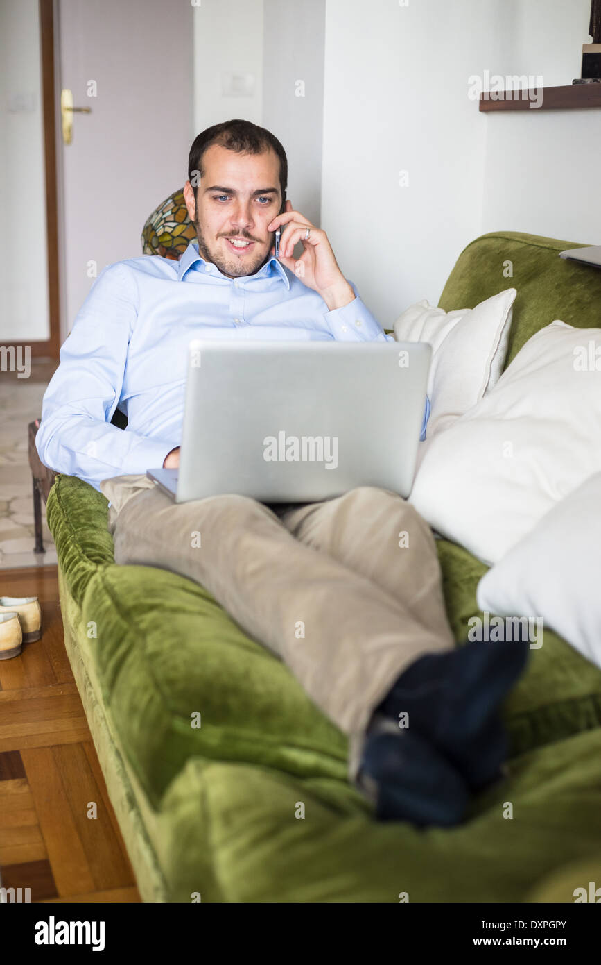elegant business multitasking multimedia man using devices at home ...