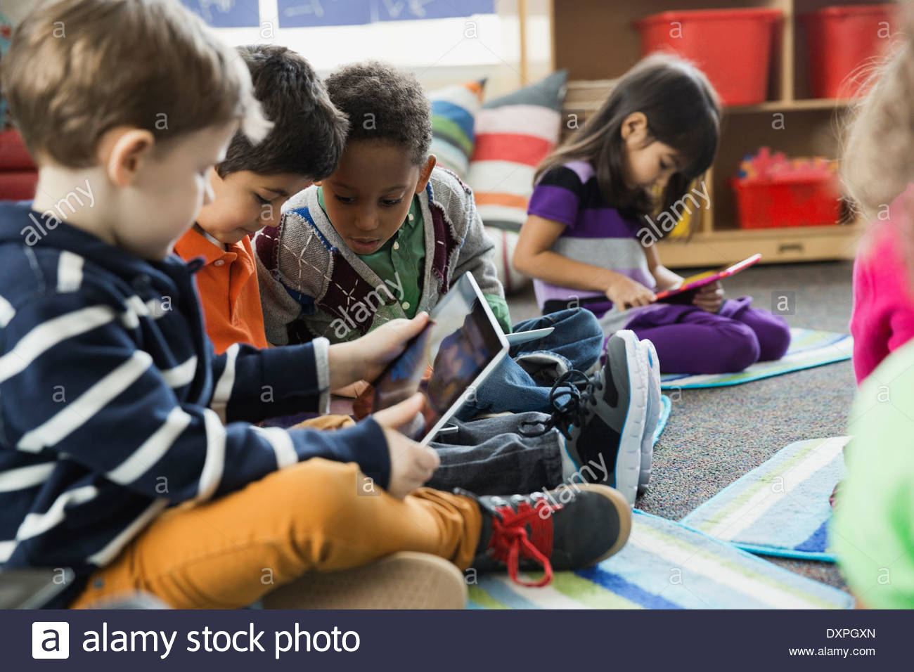 Boys using digital tablet together in elementary school Stock Photo - Alamy