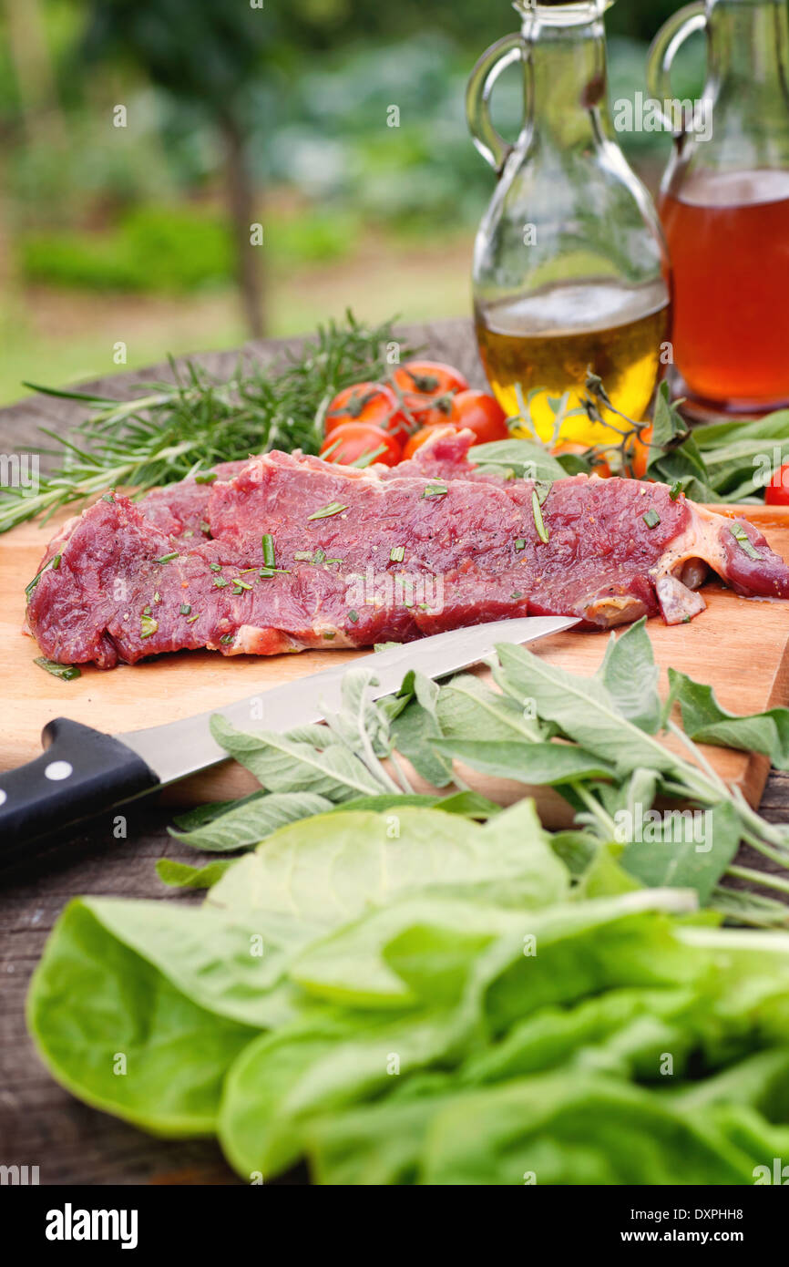 Cooking ingredients: marinated meat,oil,vinegar, herbs and vegetables ...