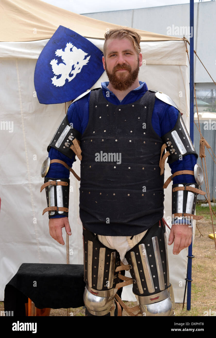 a medieval fair re-enactor suiting up for battle Stock Photo - Alamy