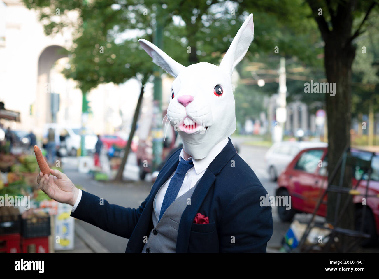 rabbit mask man with carrot in the city Stock Photo - Alamy