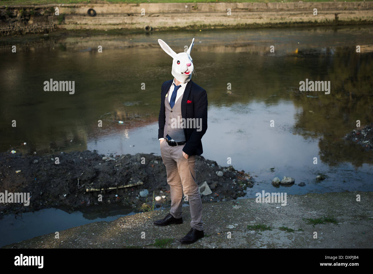 rabbit mask man in a desolate landscape river Stock Photo - Alamy