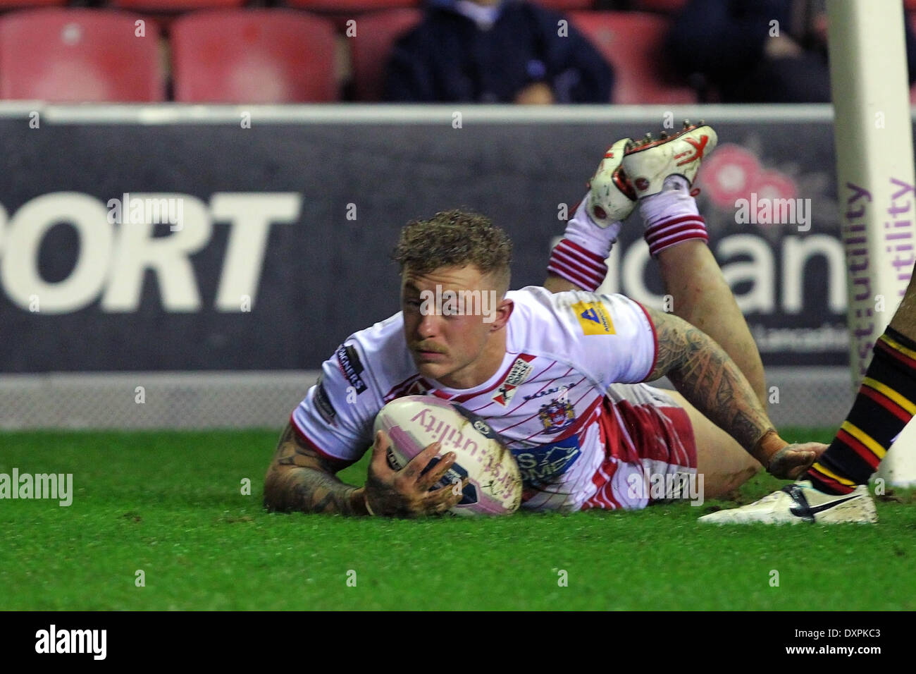 Wigan, UK. 28th Mar, 2014. Josh Charnley of Wigan Warriors dives across ...