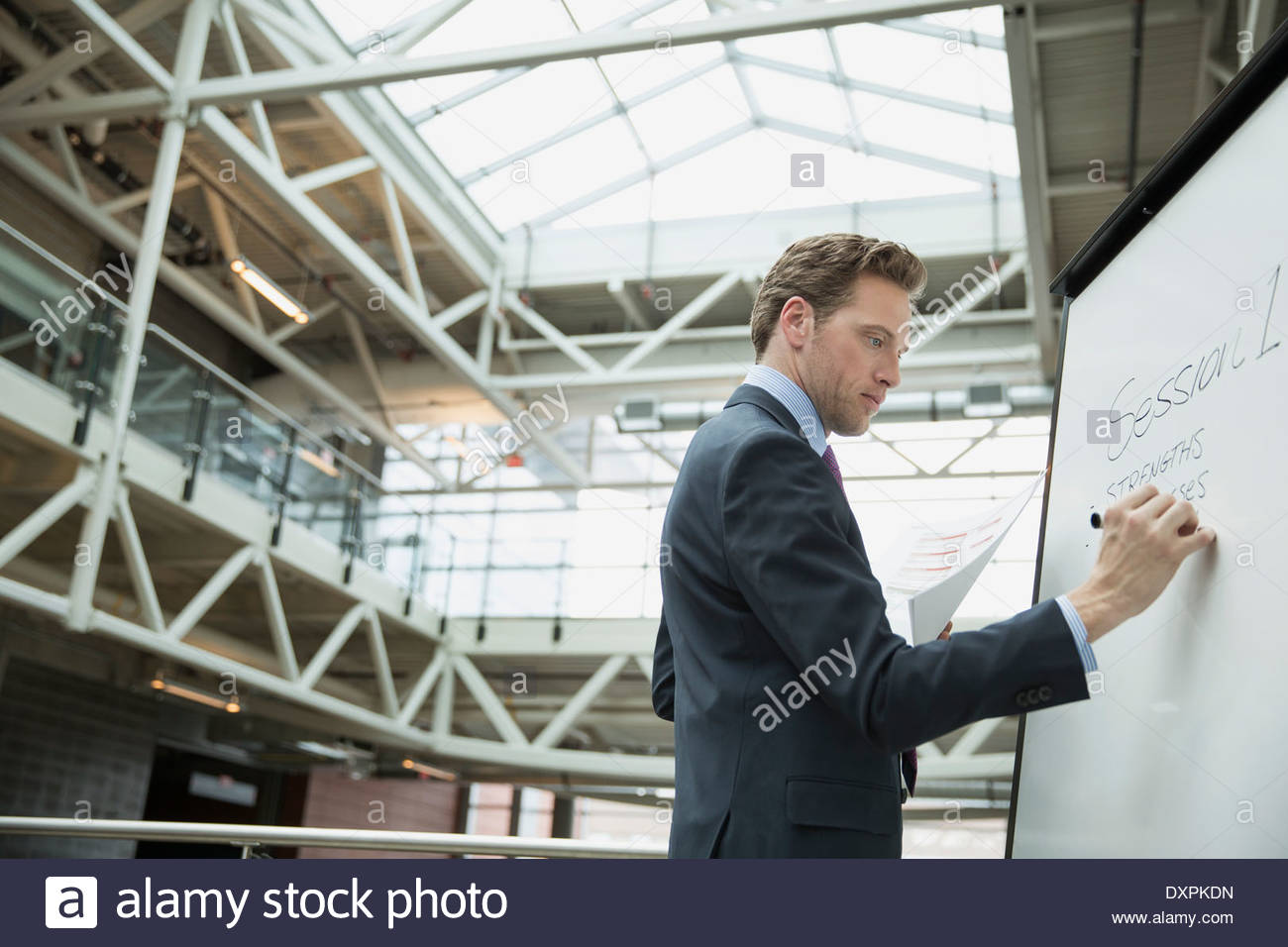 Businessman writing on whiteboard hi-res stock photography and images ...