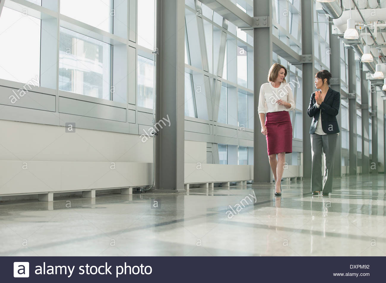 Businesswomen walking in office hi-res stock photography and images - Alamy