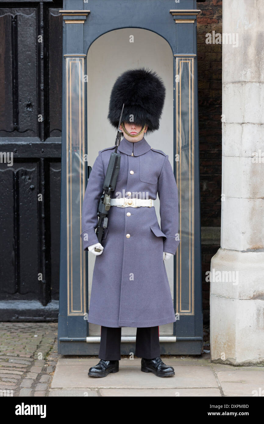 Guardsman of the Grenadier Guards standing in his sentry box outside St James's Palace, London ...