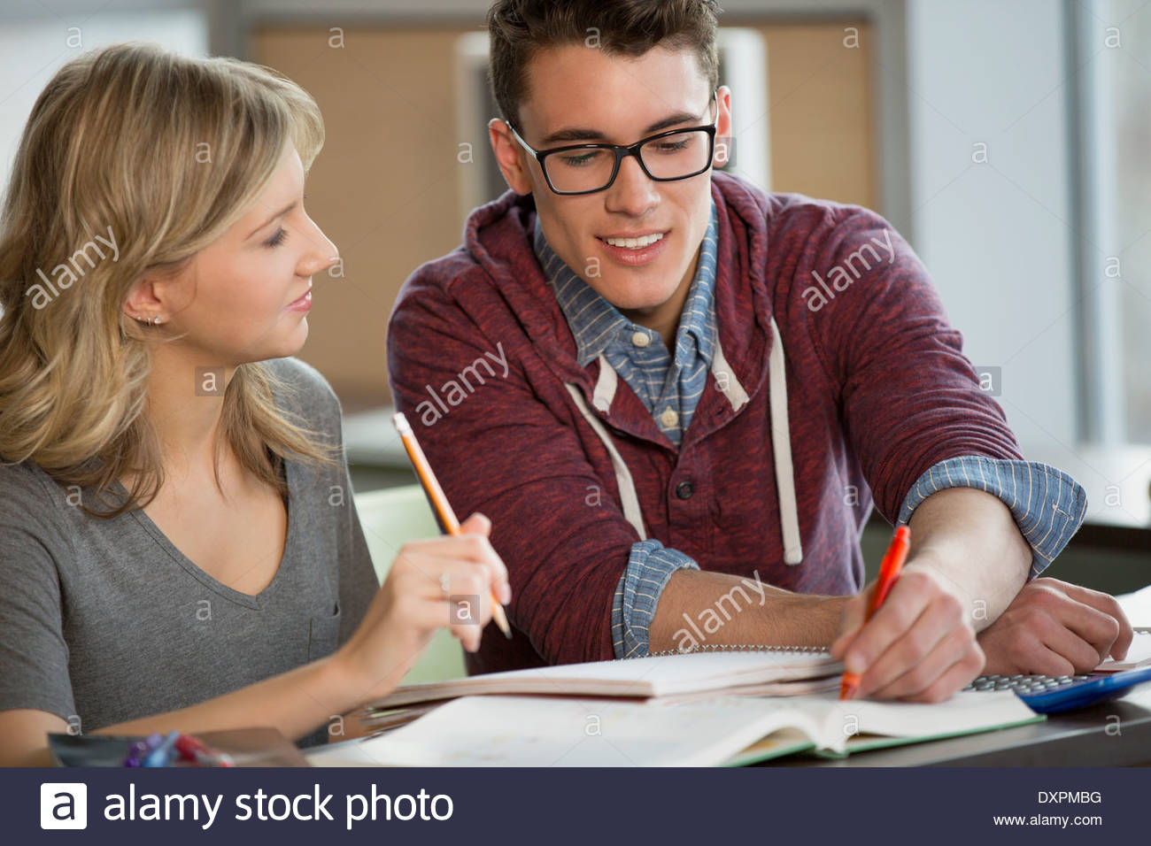 Two students talking at desk hi-res stock photography and images - Alamy