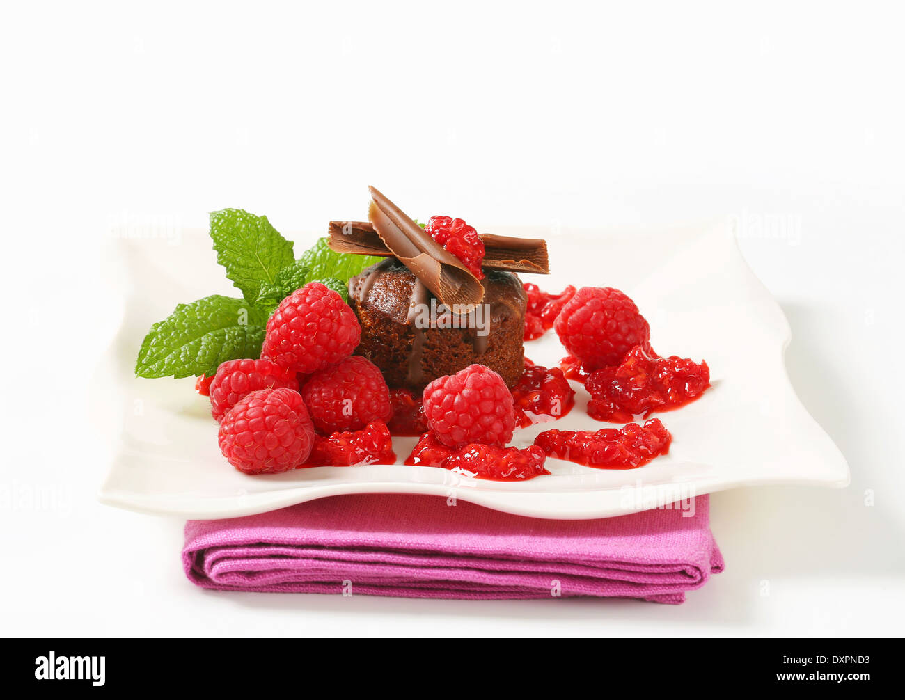 Mini chocolate cake served with fresh raspberries Stock Photo - Alamy